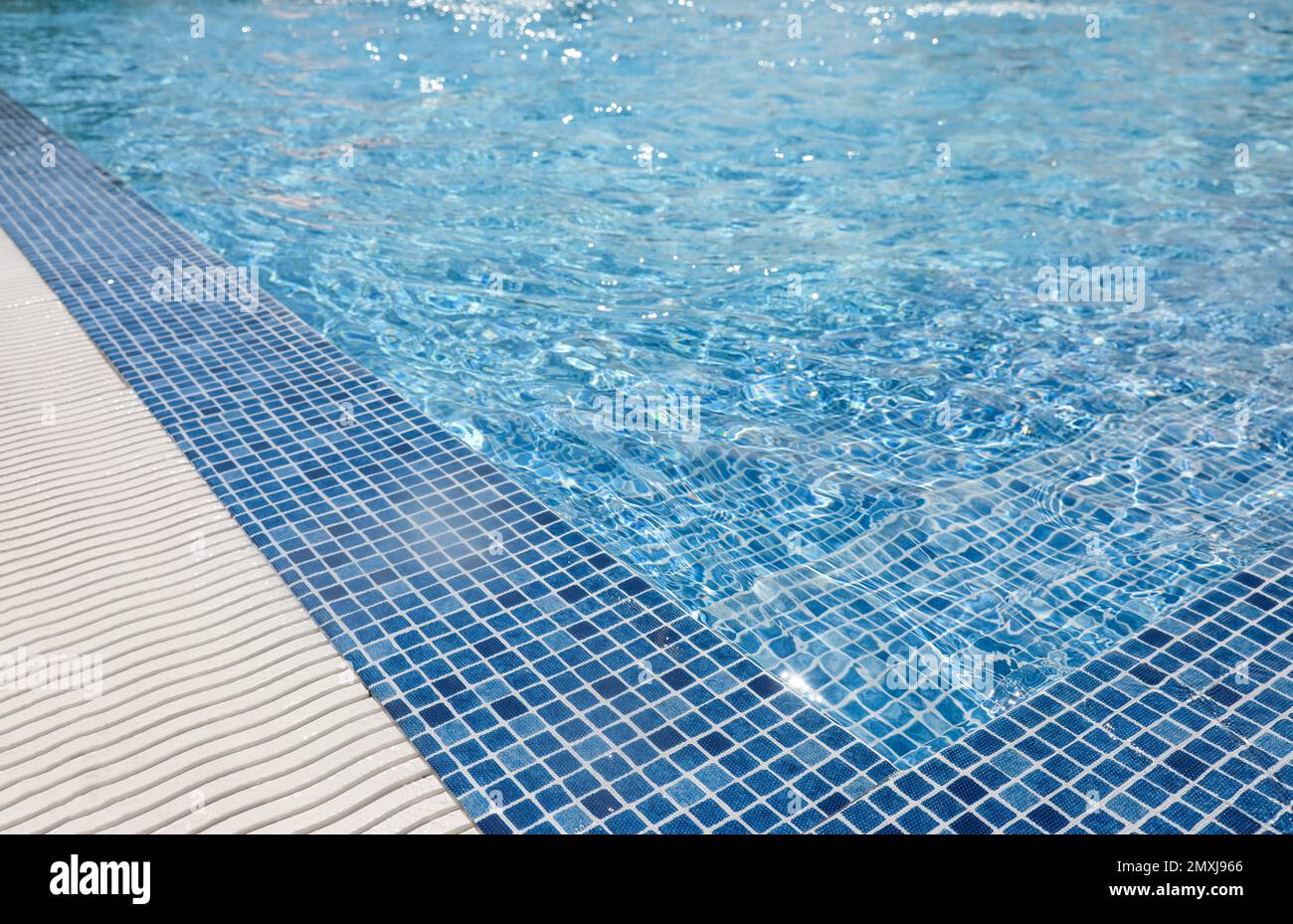 Outdoor swimming pool with clear water on sunny day. Summer vacation ...