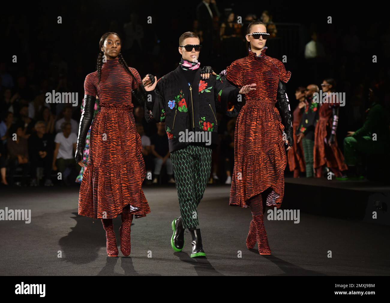 Models walk on runway during the Kenzo x H&M Runway show at Pier 36 on ...