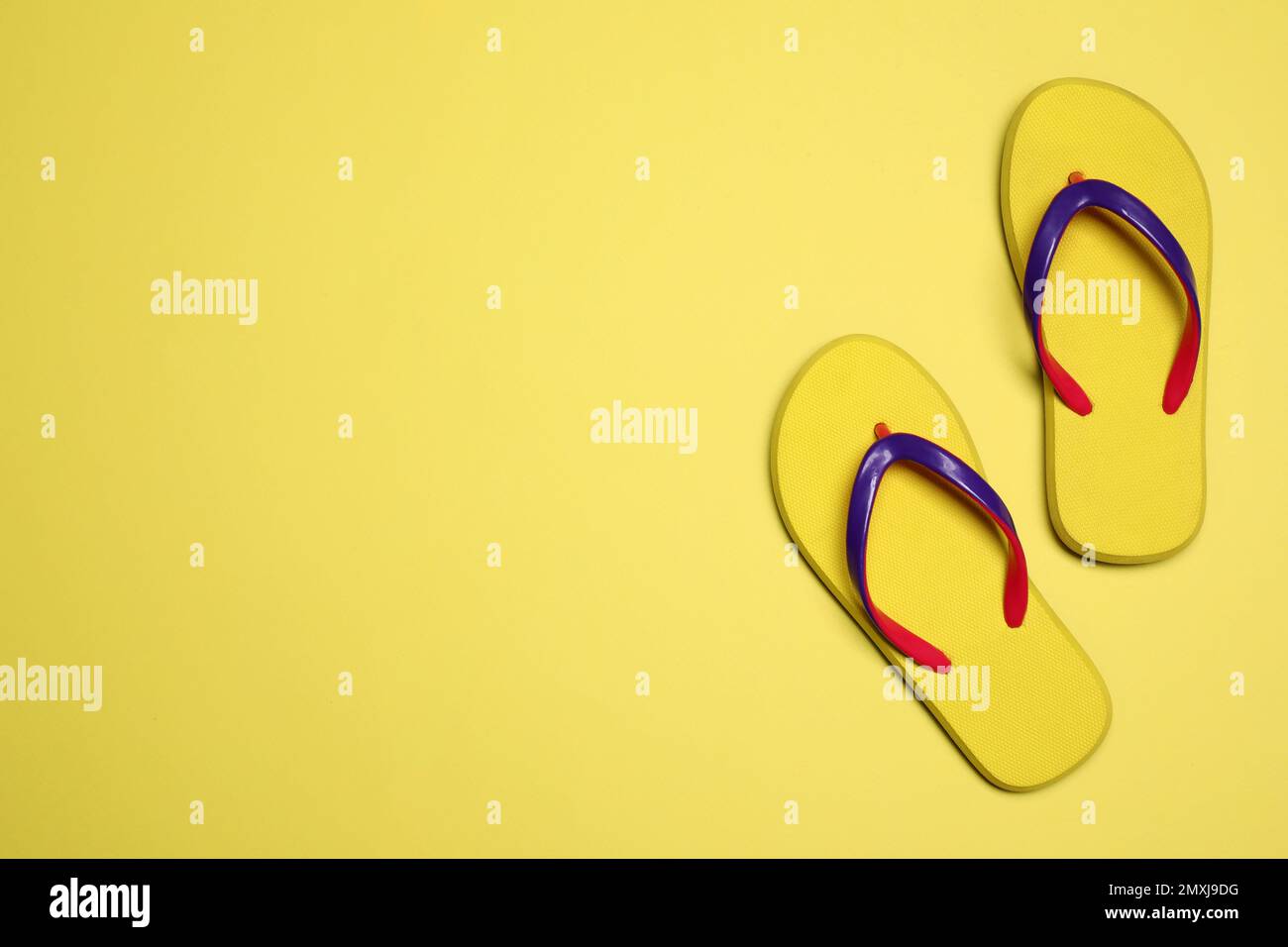 Flip flops on yellow background, top view with space for text. Beach ... Flip flops on yellow background, top view with space for text. Beach ...
