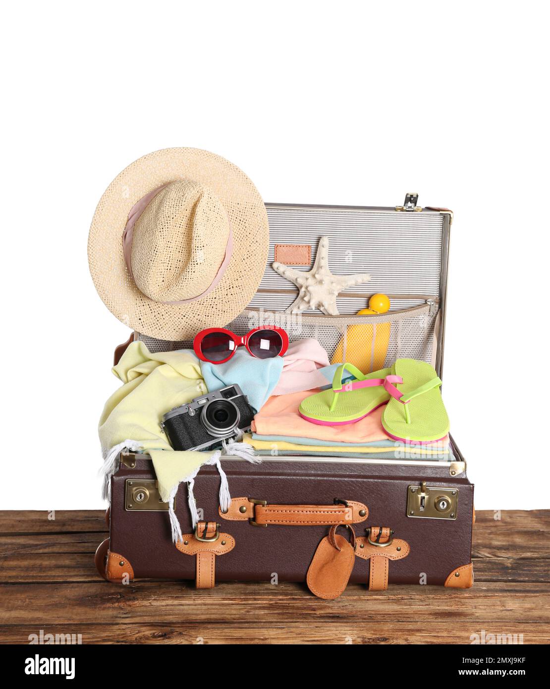 Open vintage suitcase with different beach objects packed for summer ...