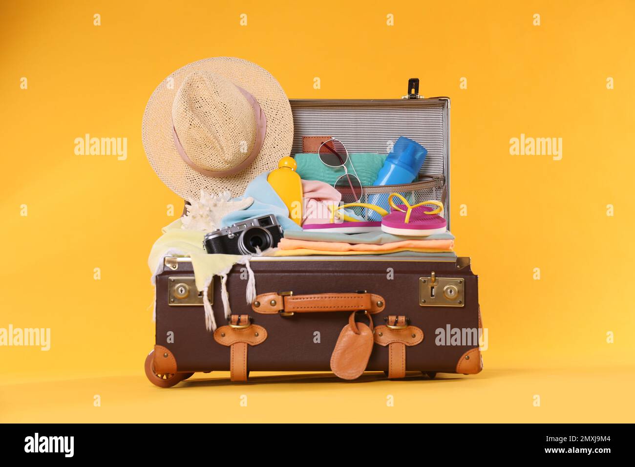Open vintage suitcase with different beach objects packed for summer ...