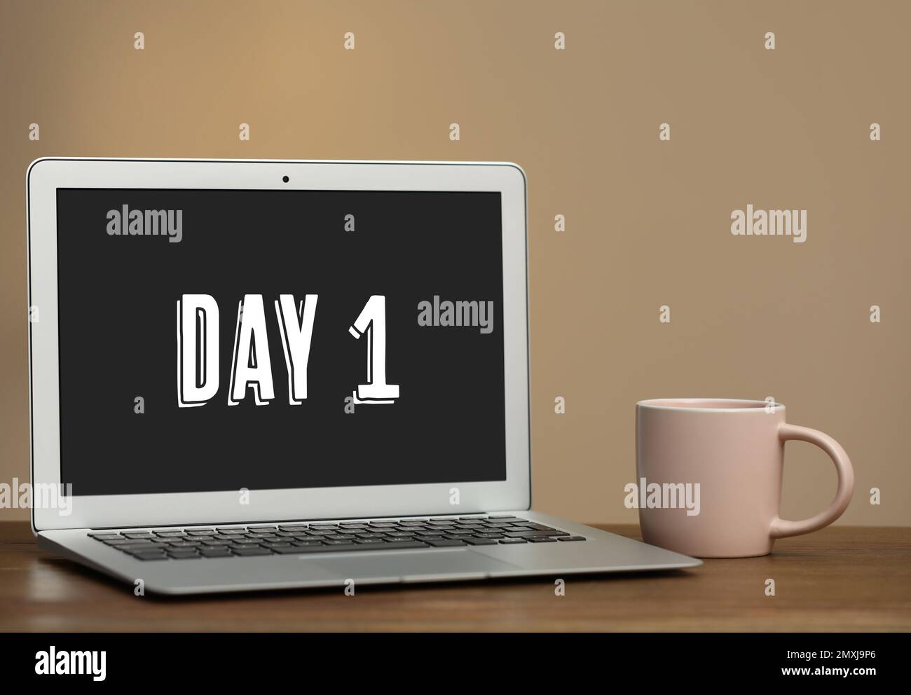 Start new job. Laptop with text Day 1 on screen and cup in office Stock ...