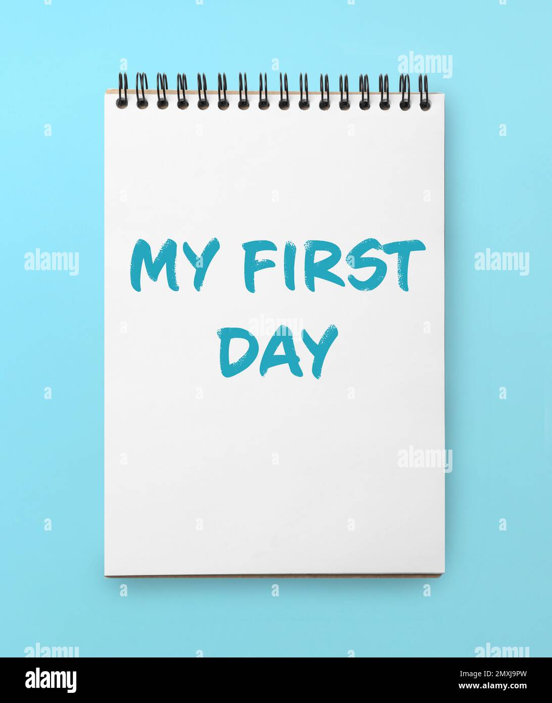 New life beginning. Notebook with text My First Day on light blue ...