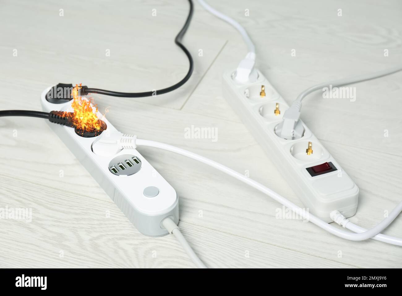 Inflamed plug in power board - result of electrical short circuit Stock ...
