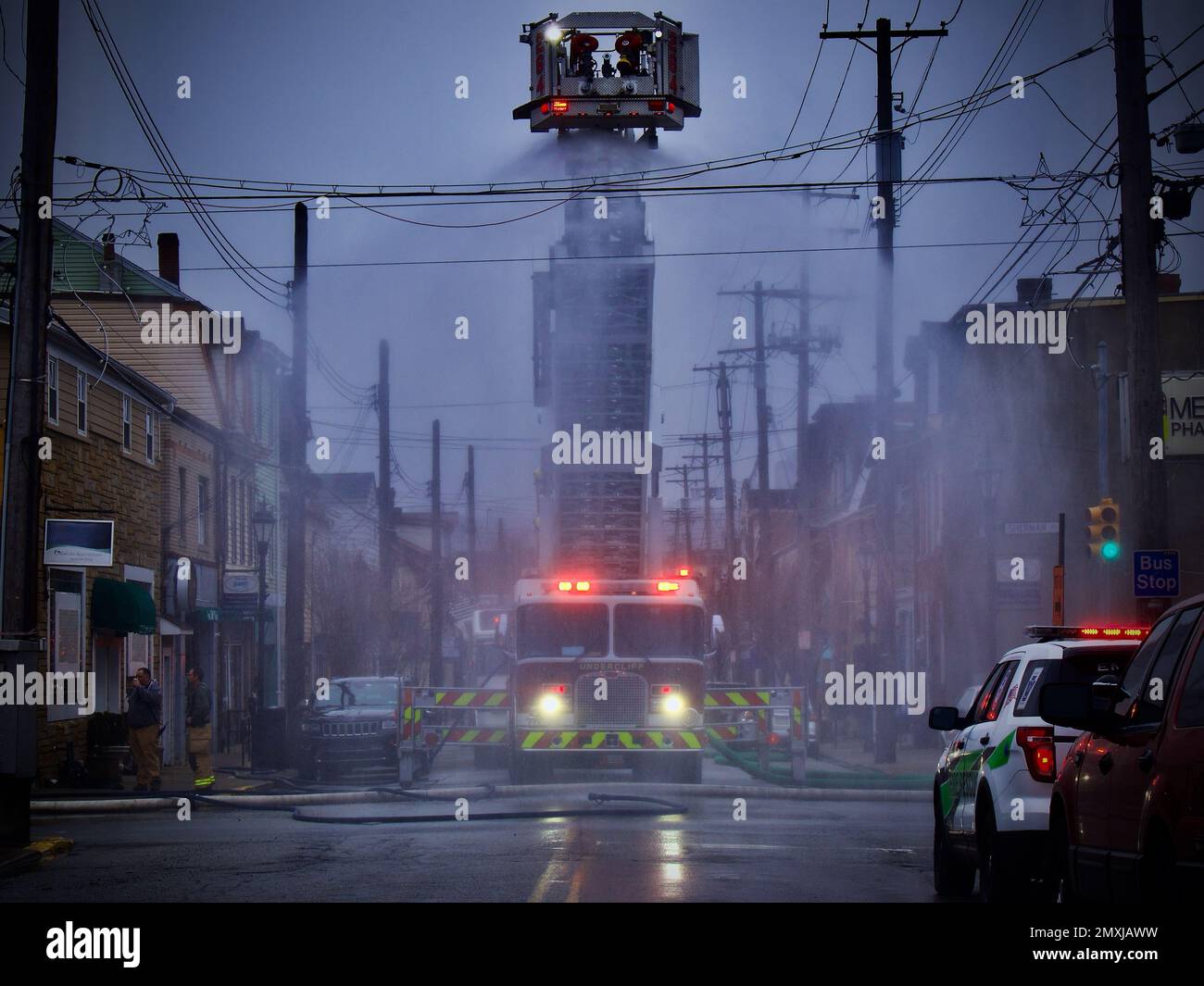 A Fire Truck Spraying water down in the middle of the road in Millvale ...