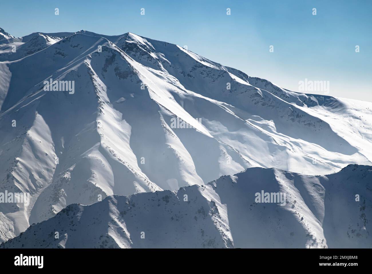 A landscape view with snowy sunlit mountain clear sky background Stock ...