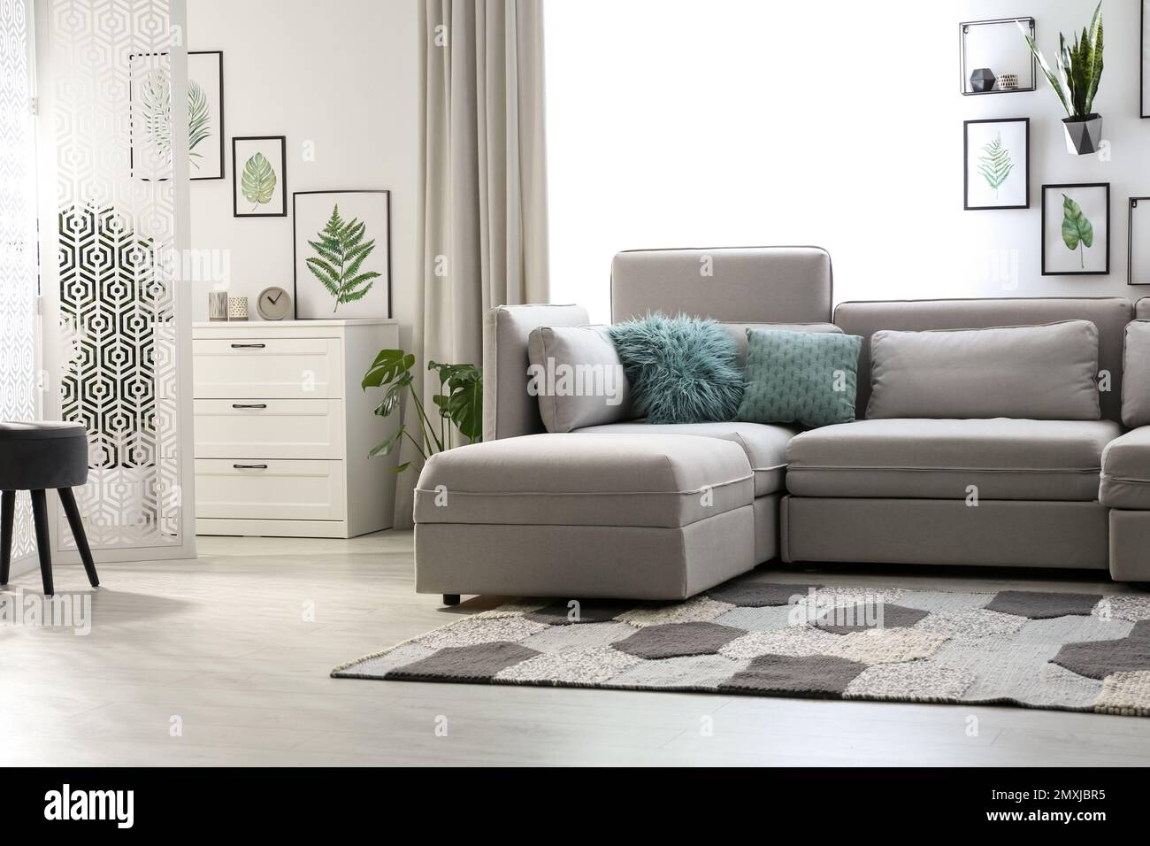 Comfortable large sofa in light room. Interior design Stock Photo - Alamy