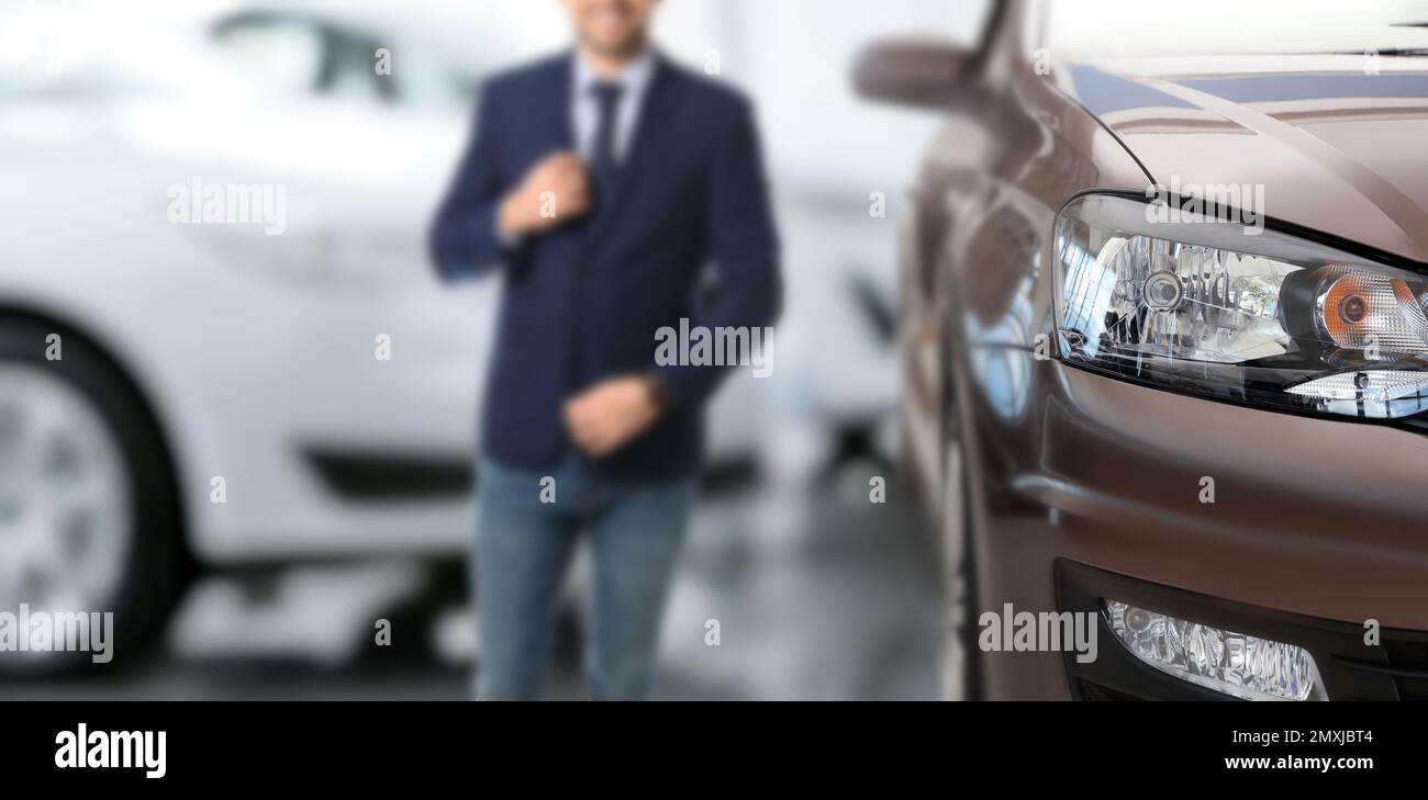 Customer choosing and buying car in auto dealership, focus on new auto ...