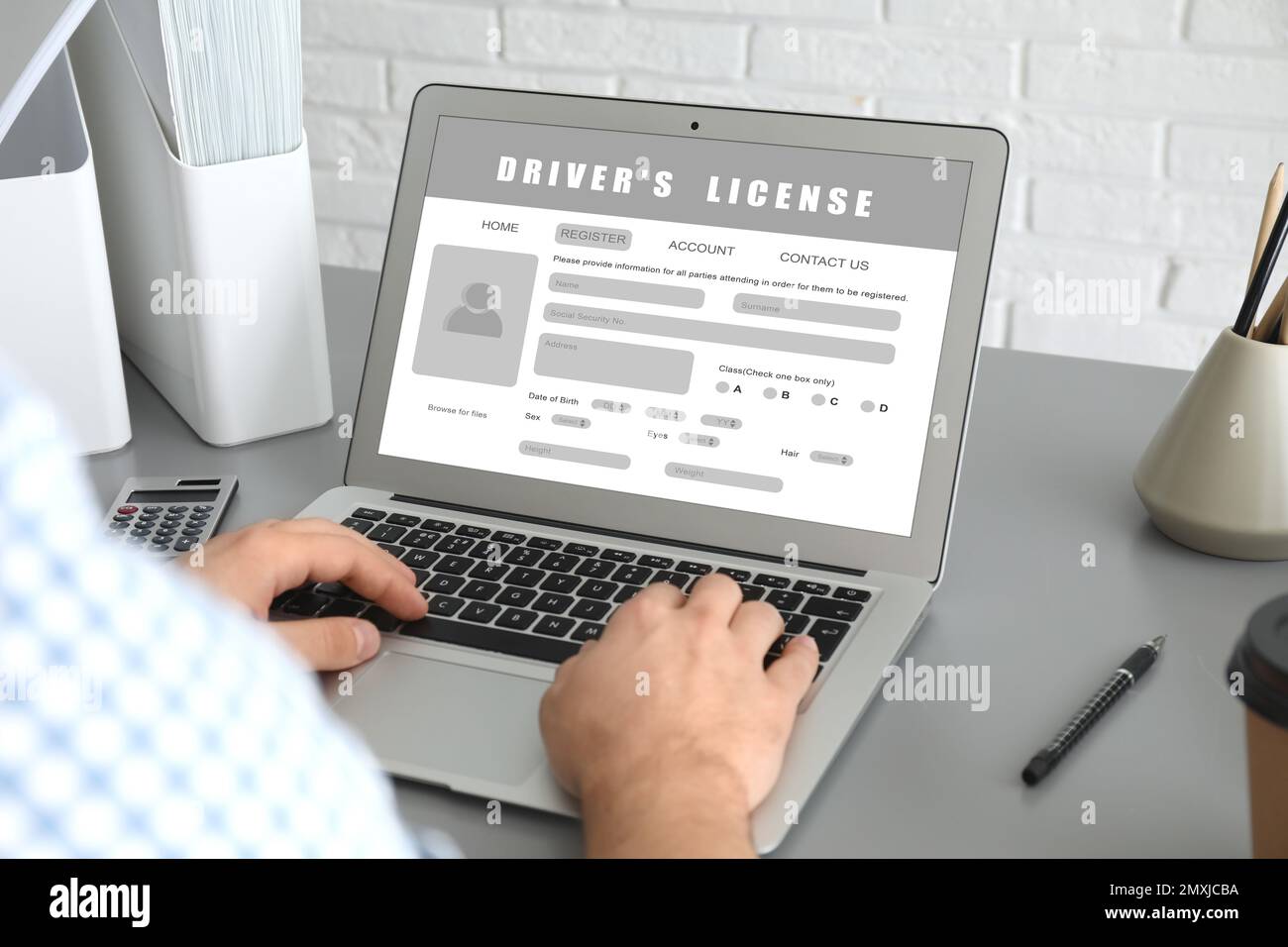Man filling in driver's license form online on website using laptop, closeup Stock Photo - Alamy