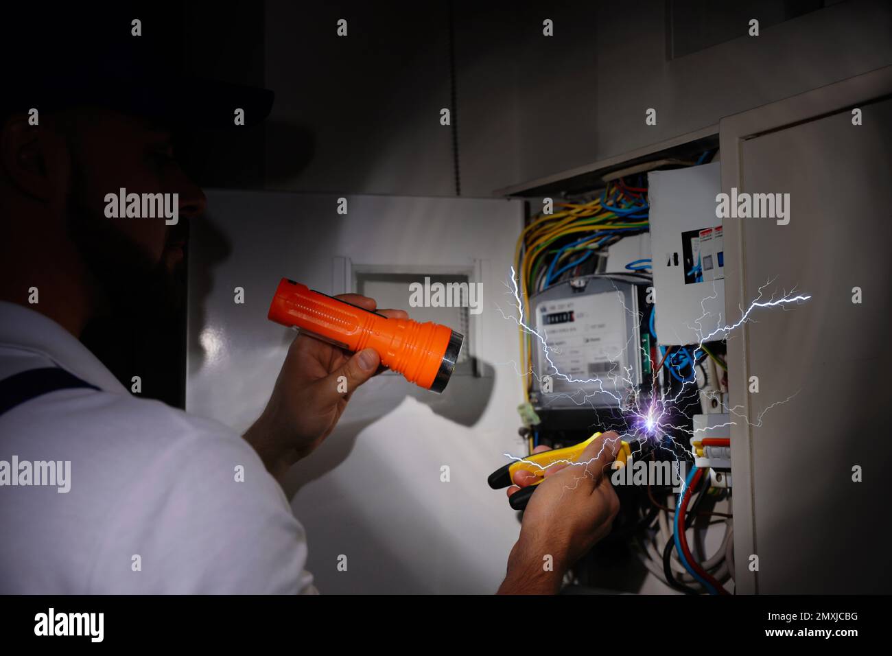 Electrician receiving electric shock while working, closeup Stock Photo ...
