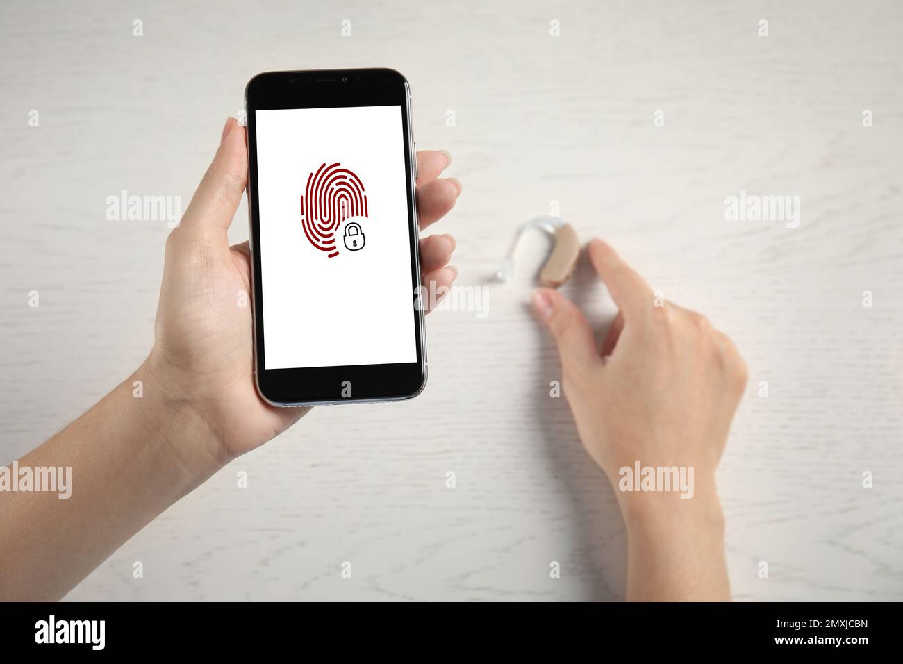 Set up hearing aid with smartphone app, fingerprint sensor on screen ...
