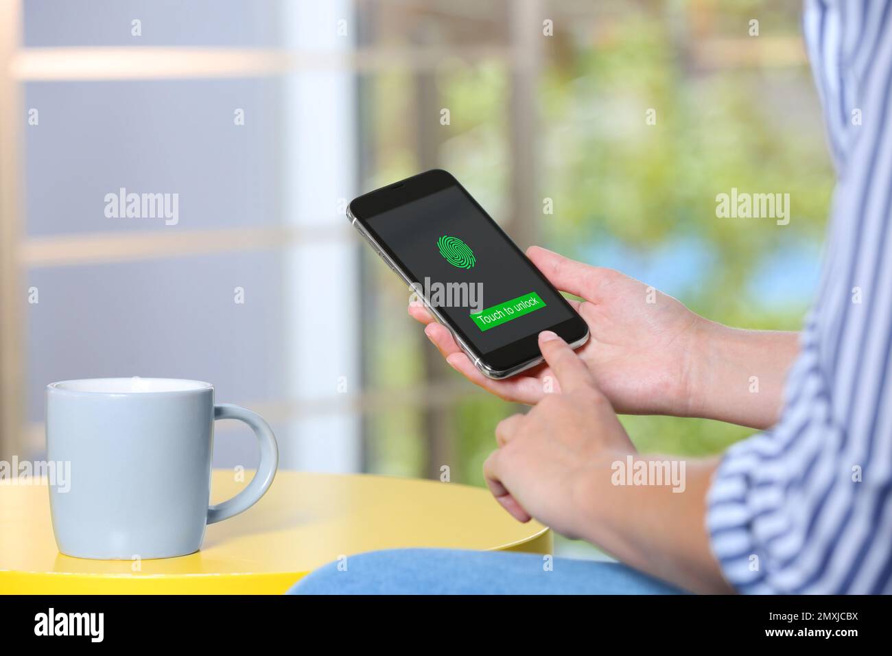 Woman scanning fingerprint on smartphone hi-res stock photography and ...