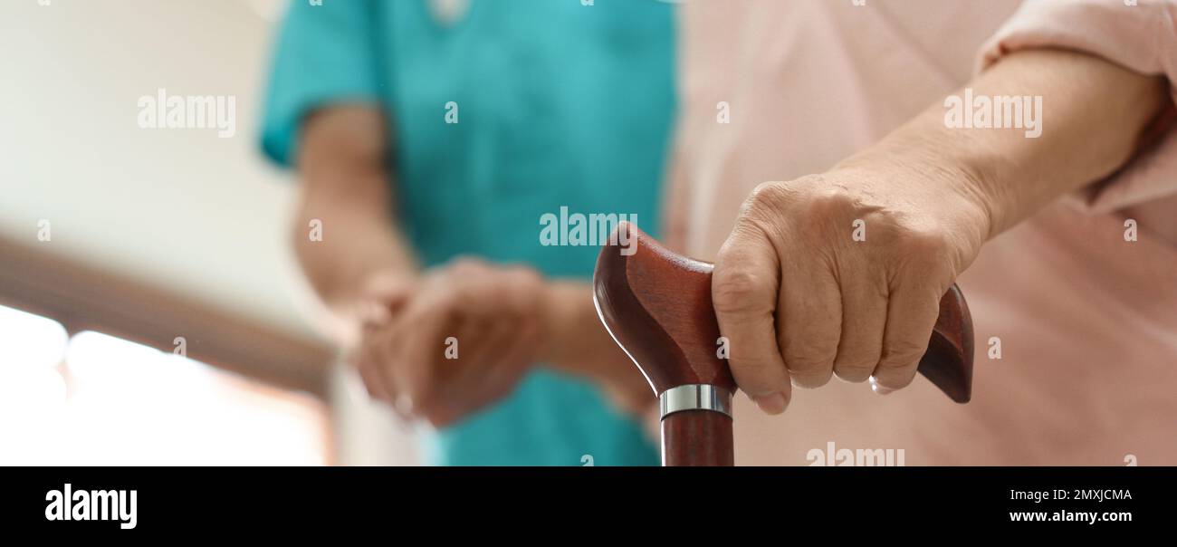 Medical worker taking care of elderly woman in geriatric hospice, space ...