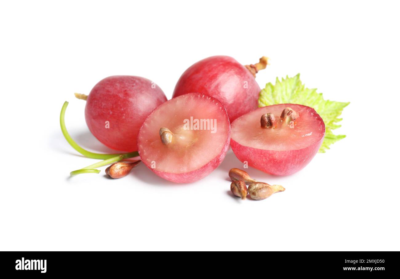 Organic red grapes and seeds on white background. Natural essential oil ...