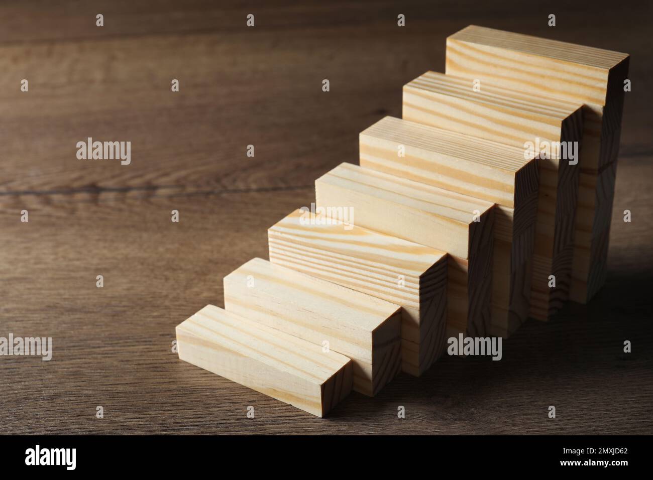 Steps made with blocks on wooden table. Career ladder Stock Photo - Alamy