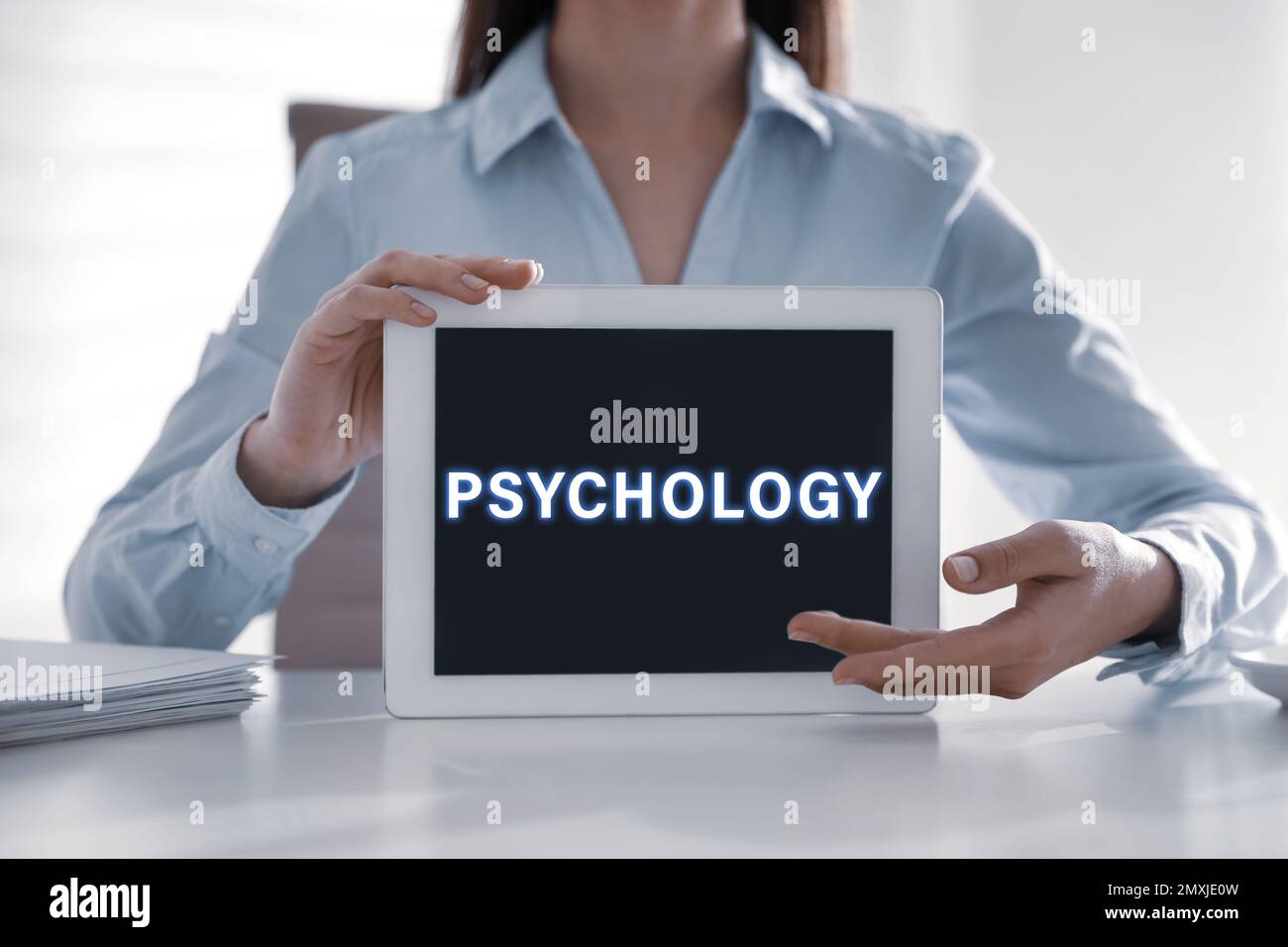 Psychologist with modern tablet at white table in office, closeup Stock ...