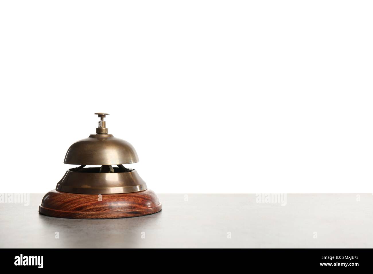 Hotel service bell on grey stone table against white background Stock ...