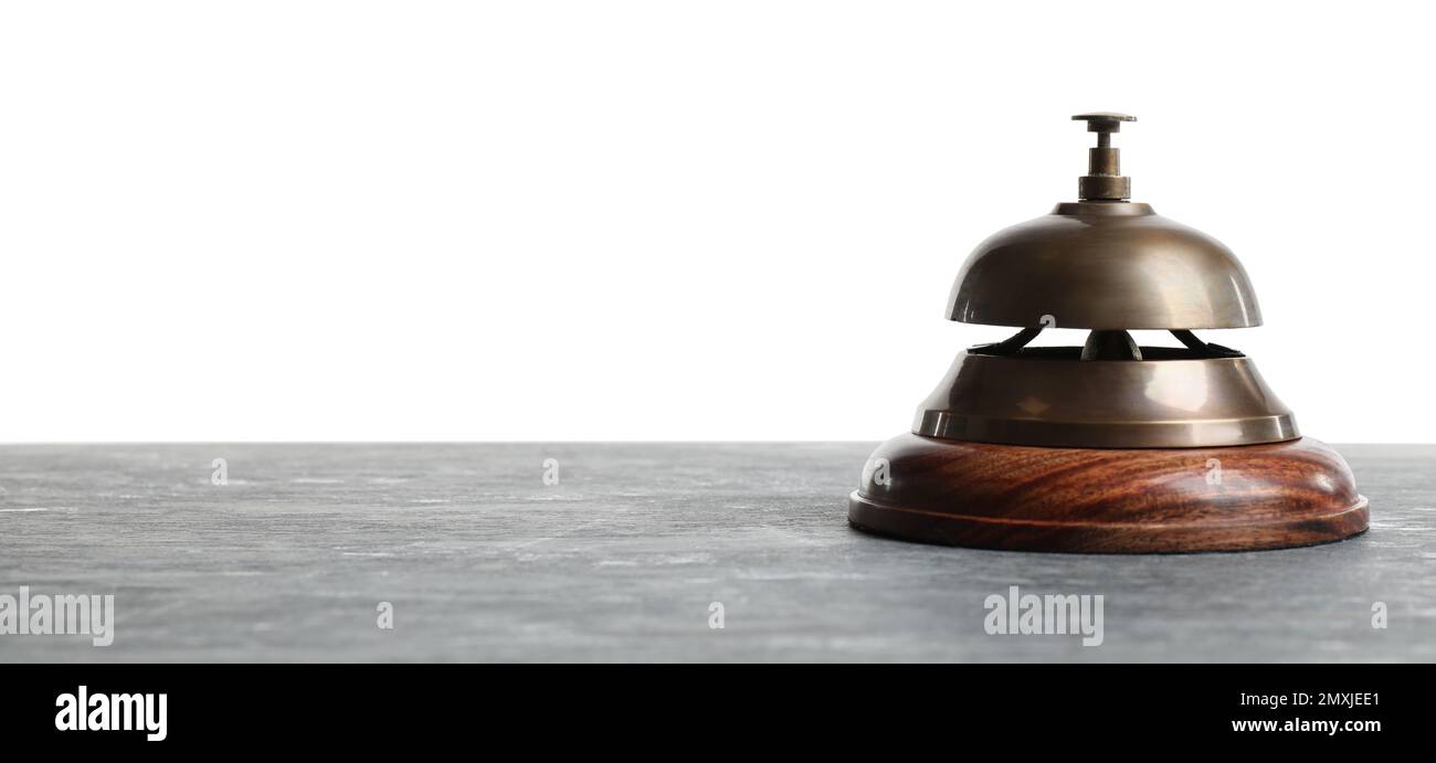Hotel service bell on grey stone table against white background Stock ...