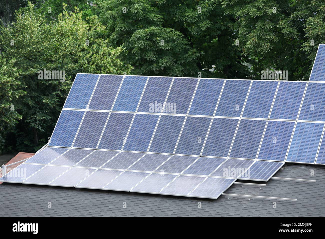 Building with installed solar panels on roof. Alternative energy source ...