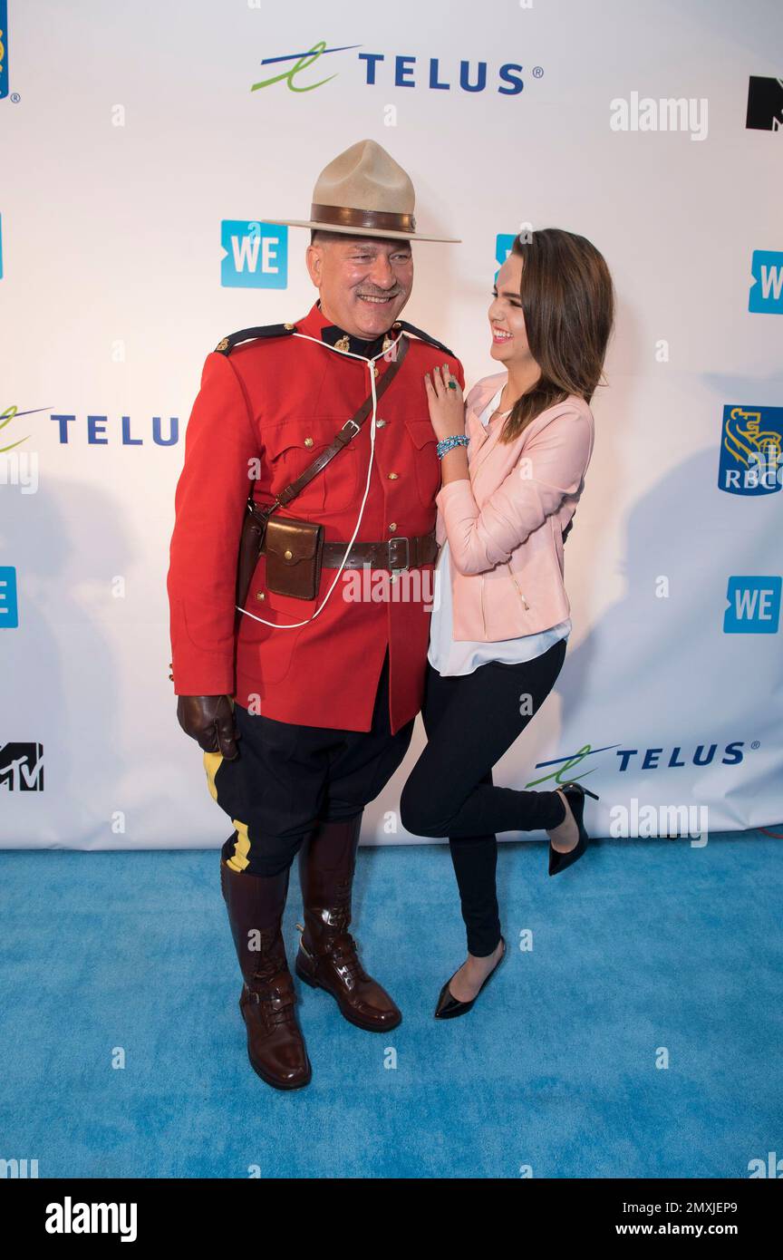 RCMP Constable Terry Russel, left, and Bailee Madison arrive at WE Day ...