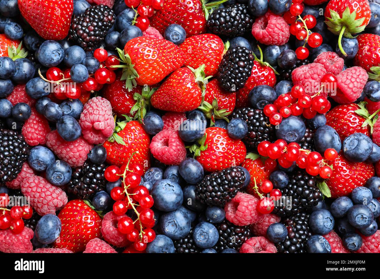 Mix of different ripe tasty berries as background, top view Stock Photo ...