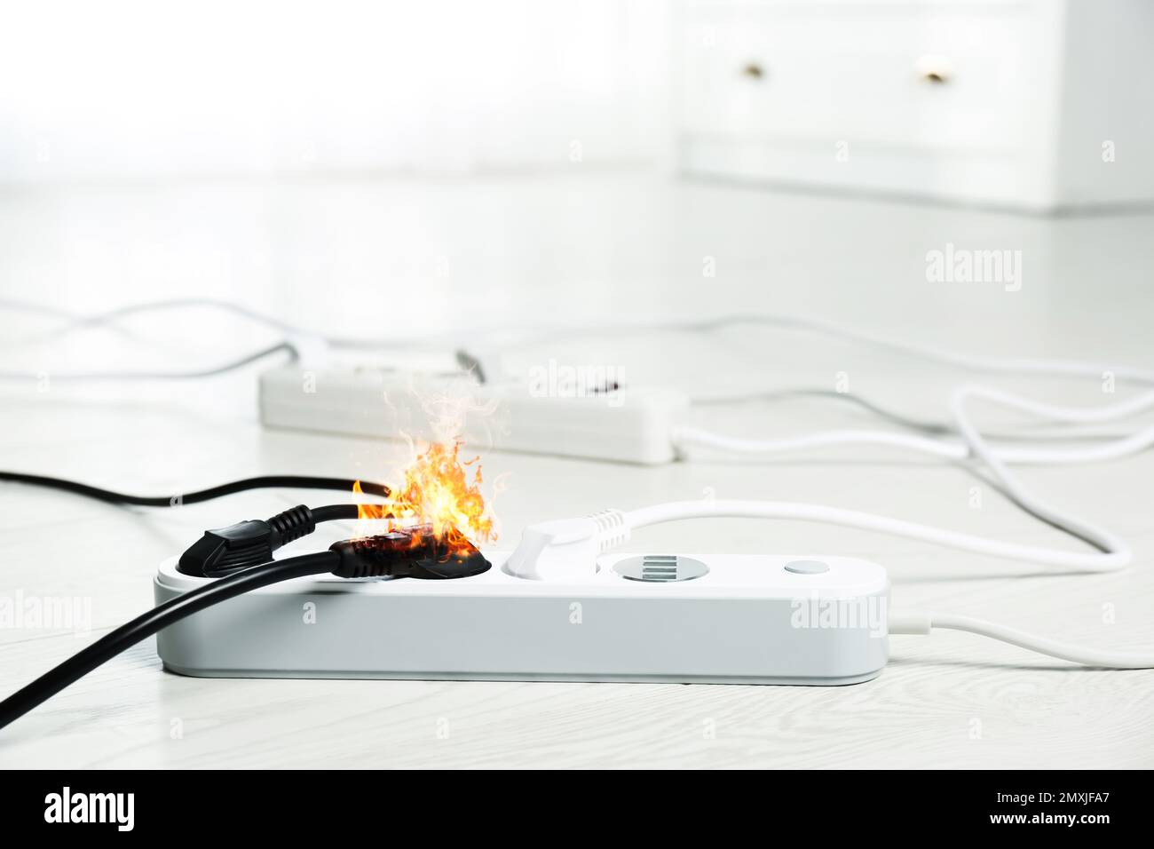 Inflamed plug in power board - result of electrical short circuit Stock ...