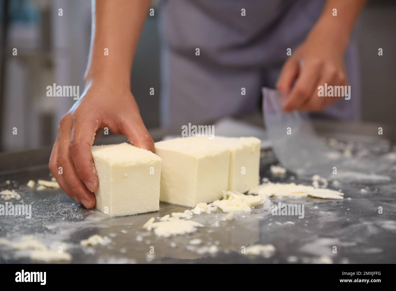 Worker packaging feta cheese at modern factory, closeup Stock Photo - Alamy