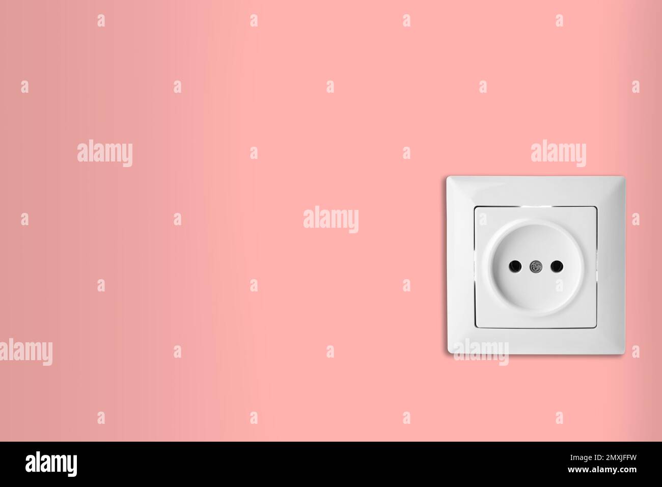 Pink wall with power socket, space for text. Electrical supply Stock ...