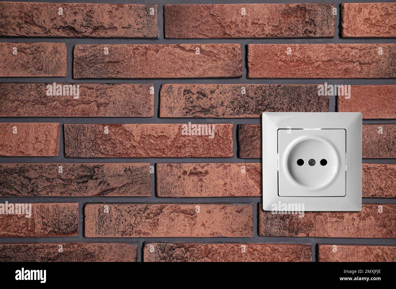 Brick wall with power socket, space for text. Electrical supply Stock ...