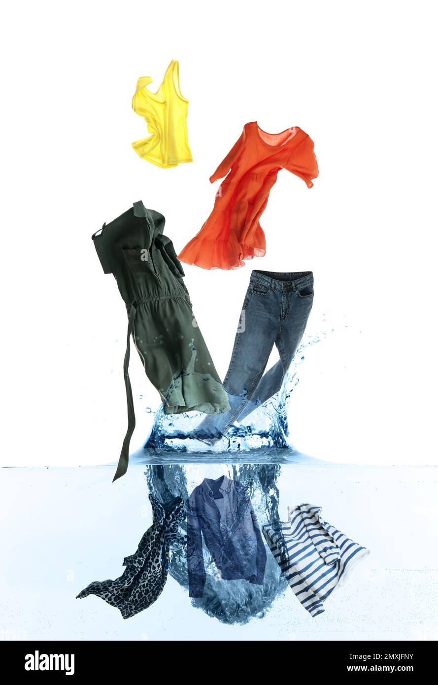 Different clothes falling into water against white background Stock ...