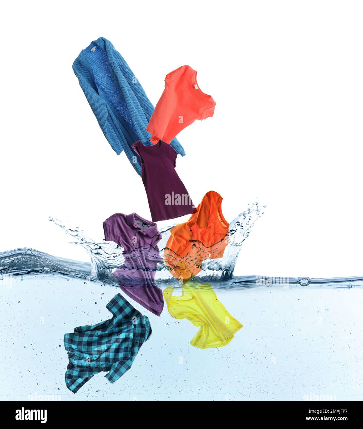 Different clothes falling into water against white background Stock ...