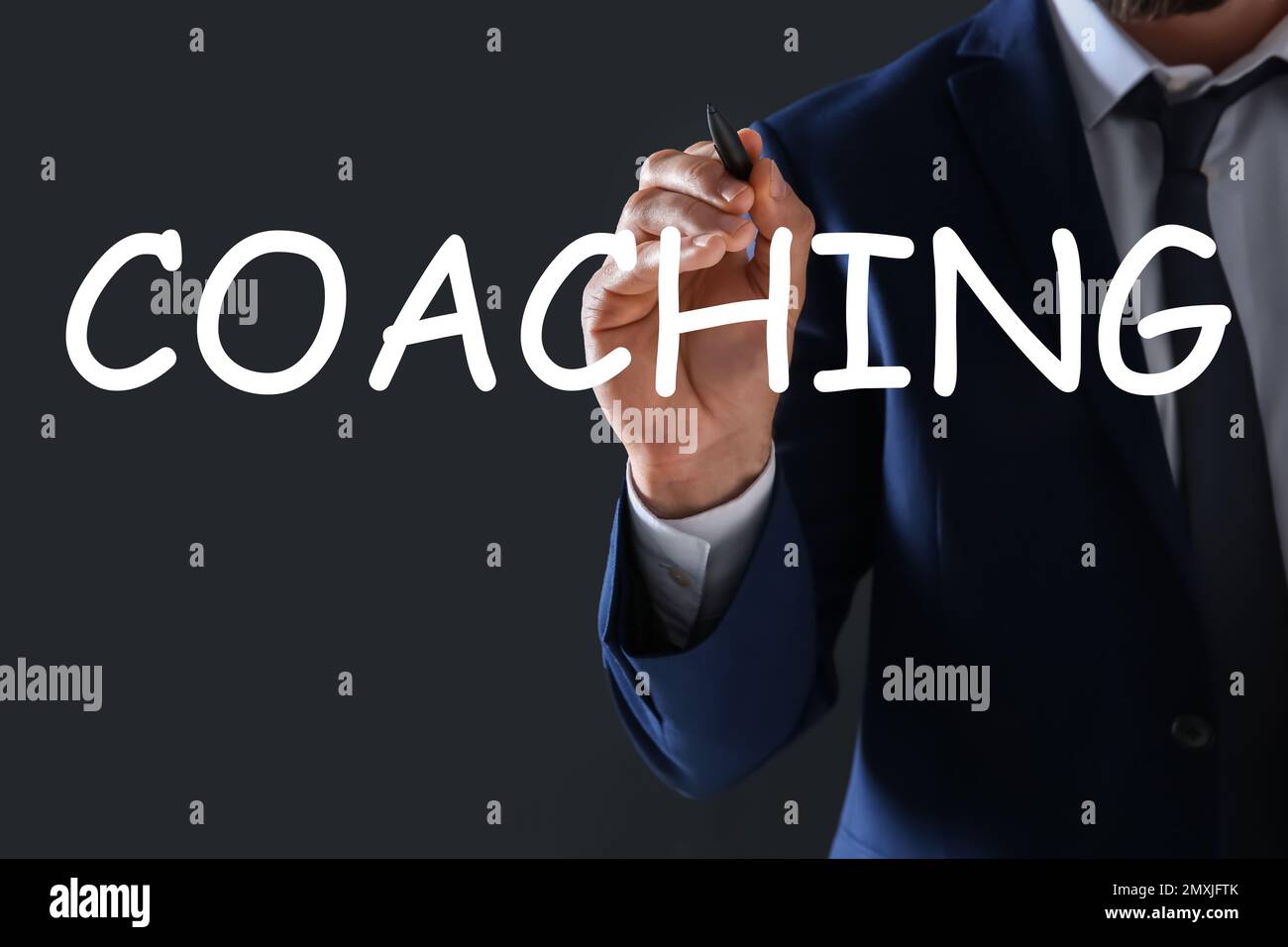 Business trainer writing word Coaching on virtual screen, closeup Stock ...