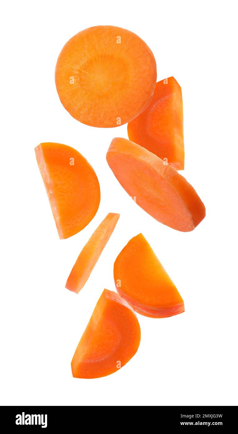 Fresh carrot slices falling on white background Stock Photo - Alamy