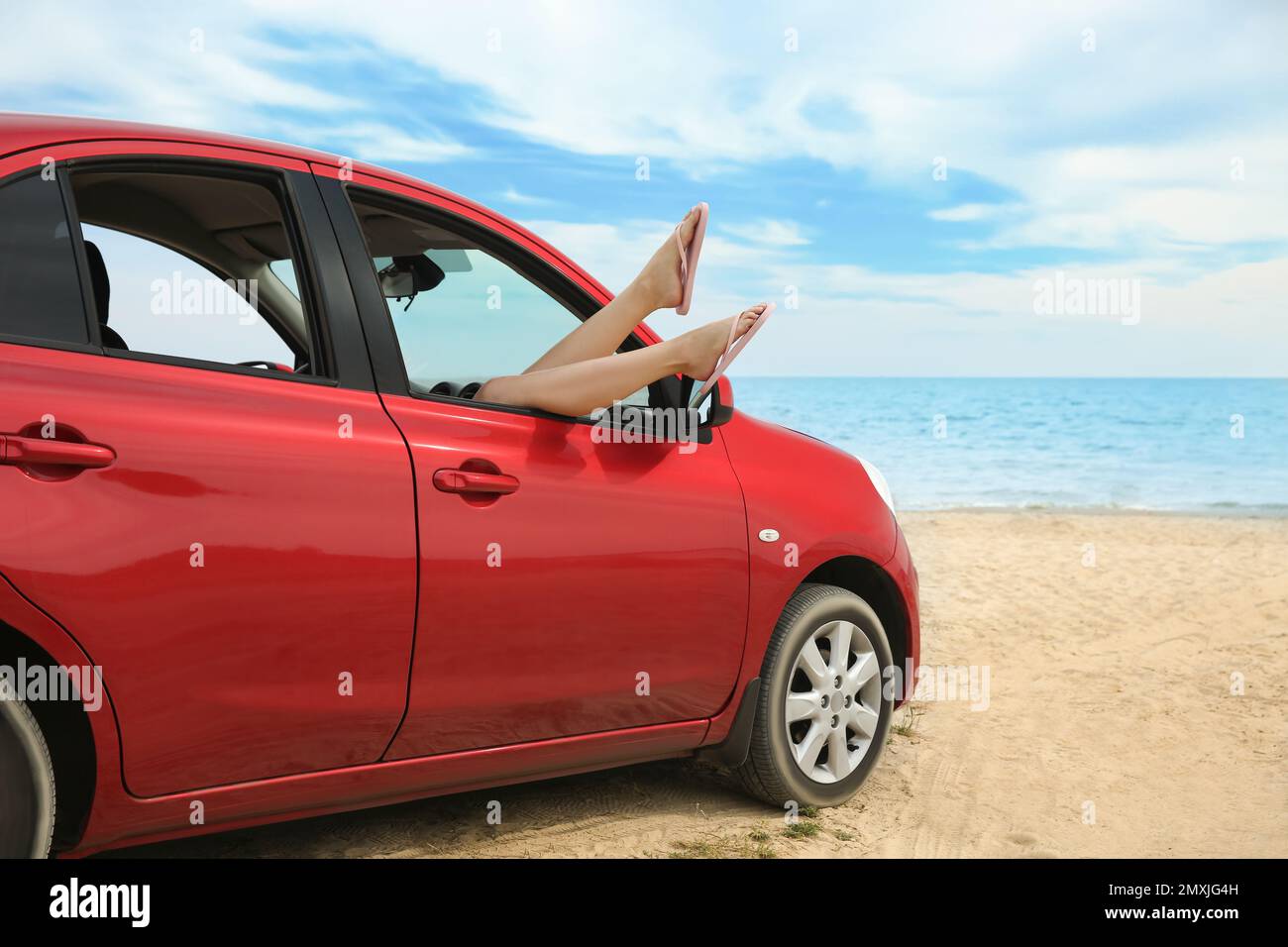 Woman showing legs from car, closeup. Summer vacation trip Stock Photo ...