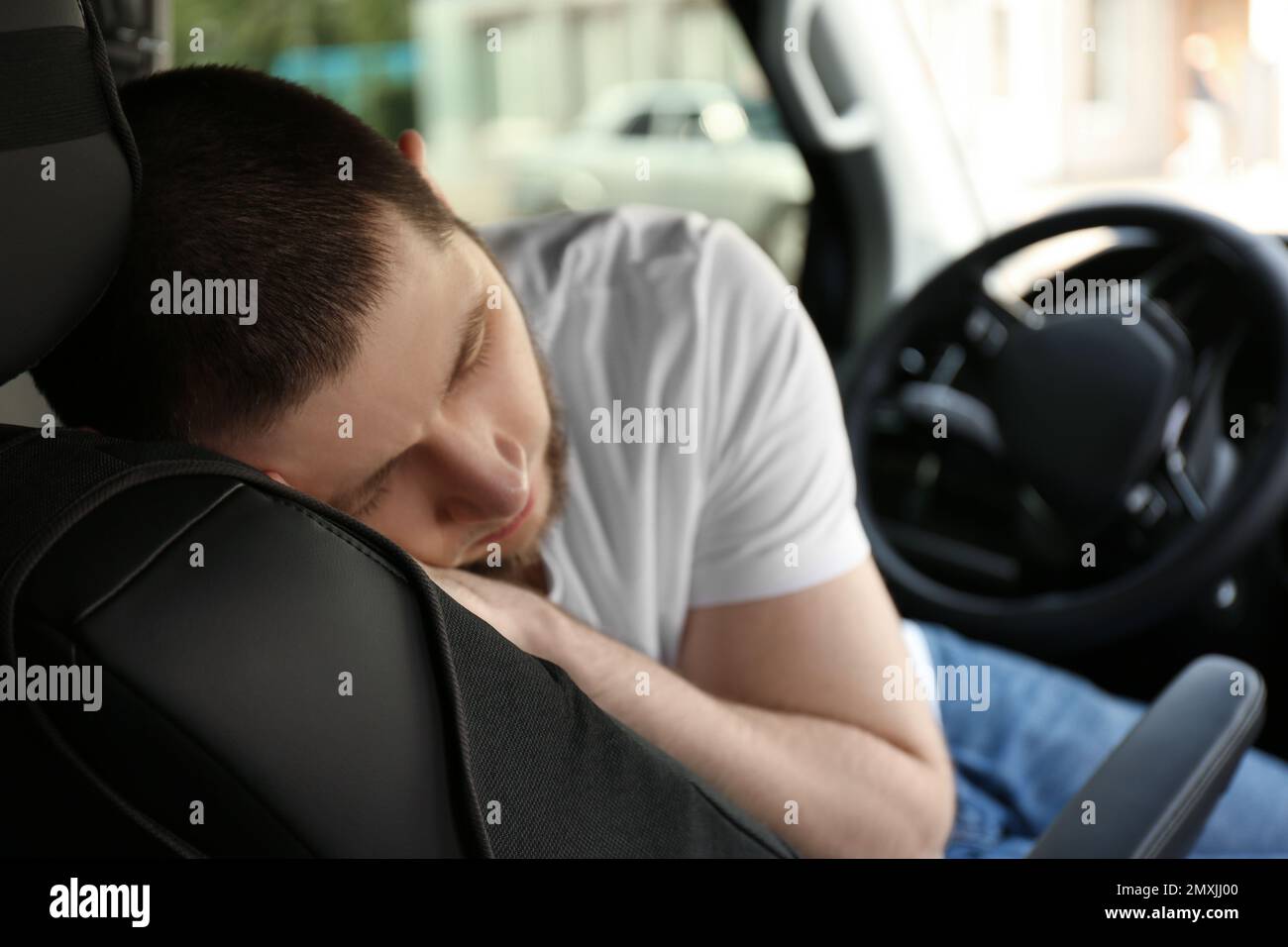 Tired man sleeping in his modern car Stock Photo - Alamy