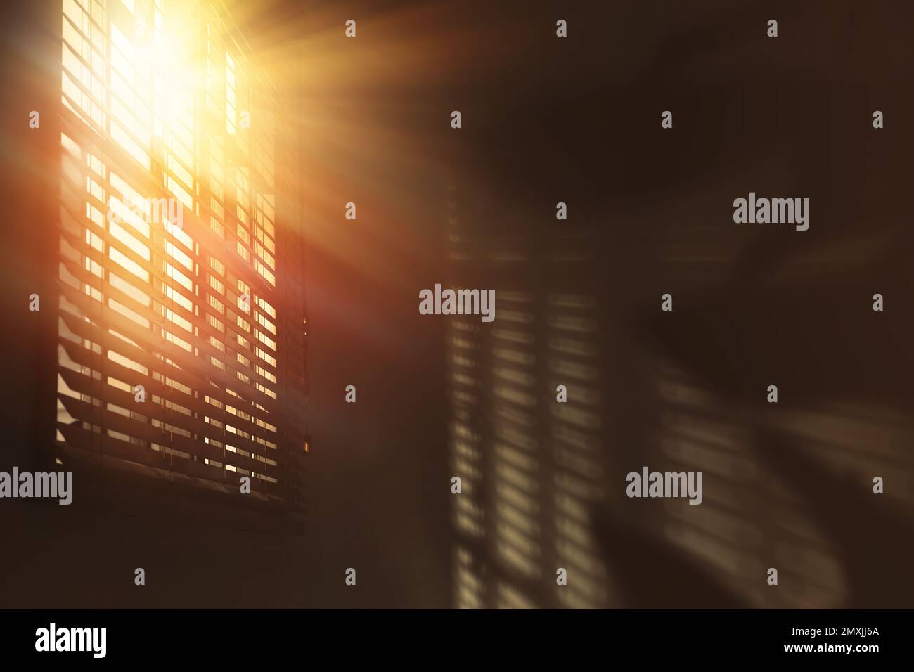 Sun shining through window blinds in room Stock Photo - Alamy