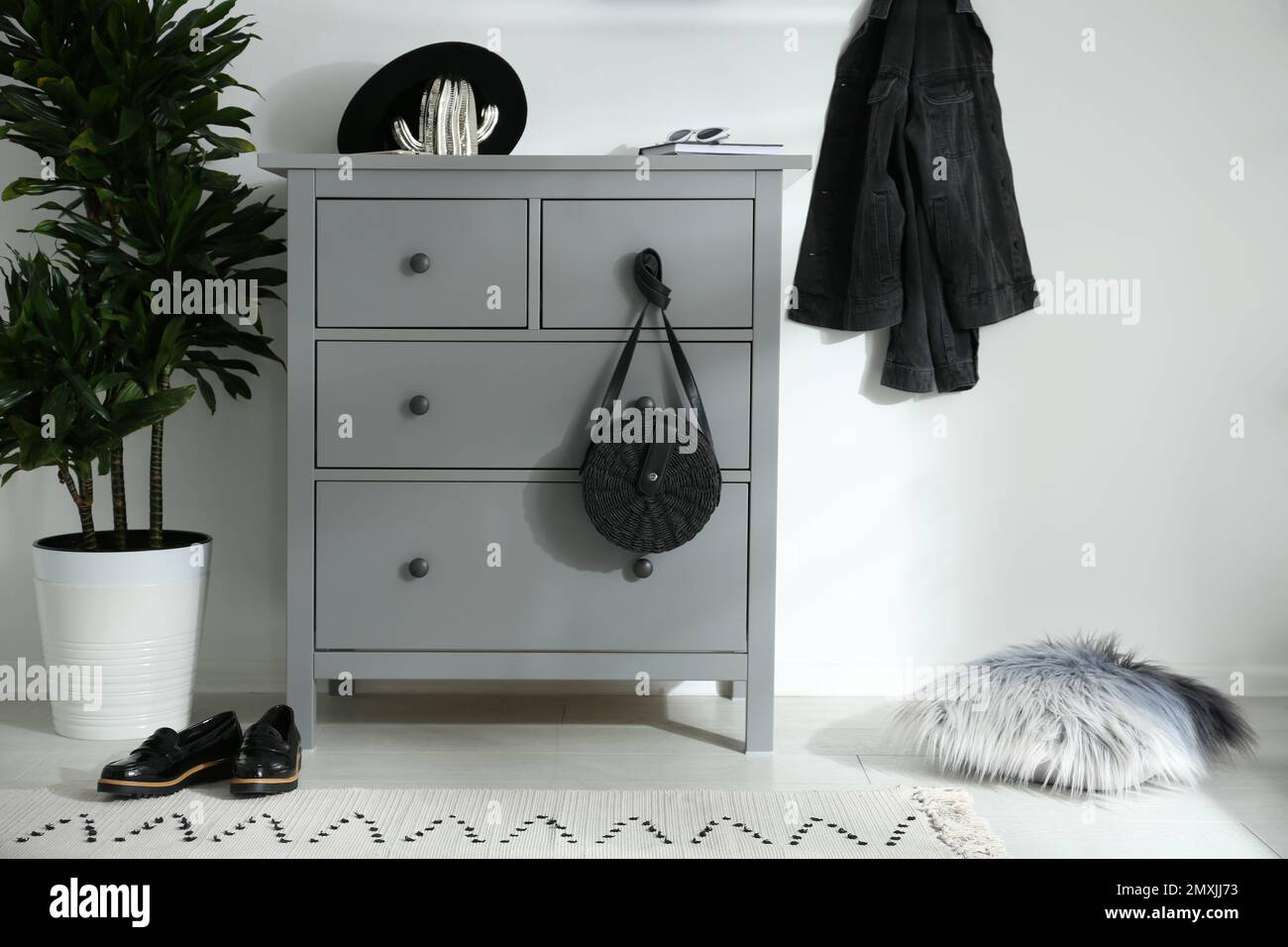 Grey chest of drawers in stylish room. Interior design Stock Photo - Alamy