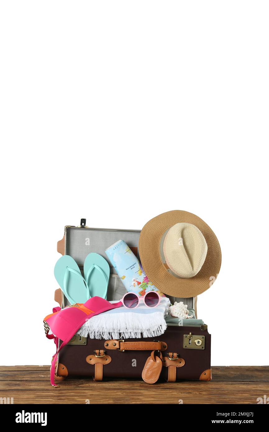 Open vintage suitcase with different beach objects packed for summer ...