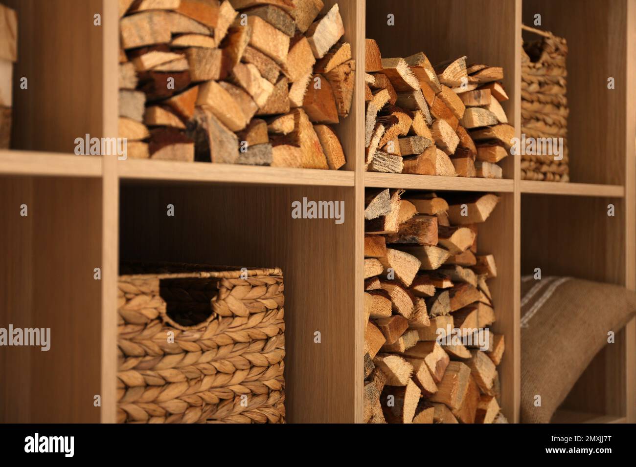 Shelving unit with stacked firewood, closeup. Idea for interior design ...