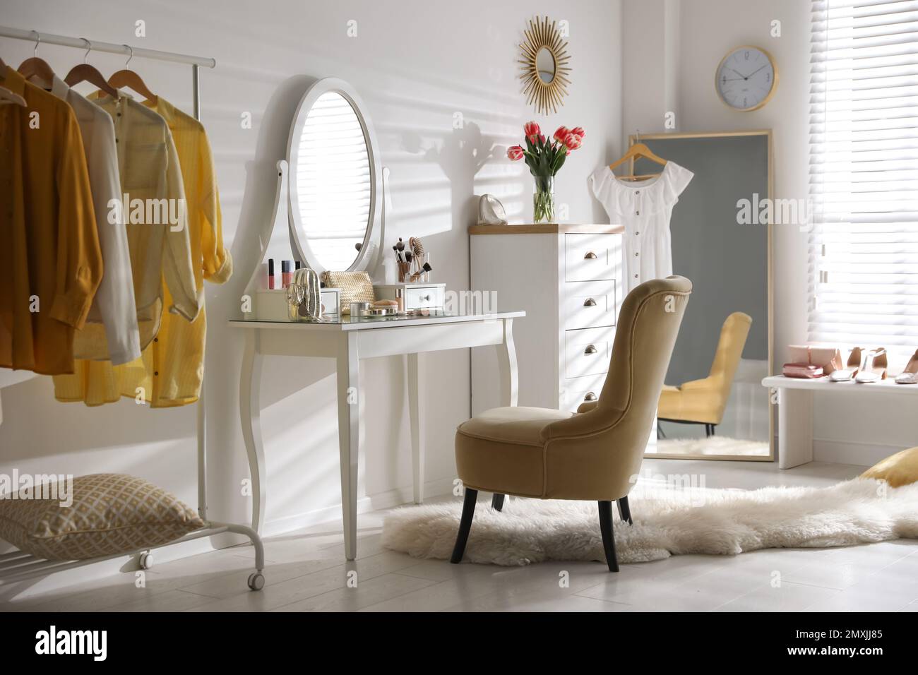 Stylish room interior with elegant dressing table, mirror and ...