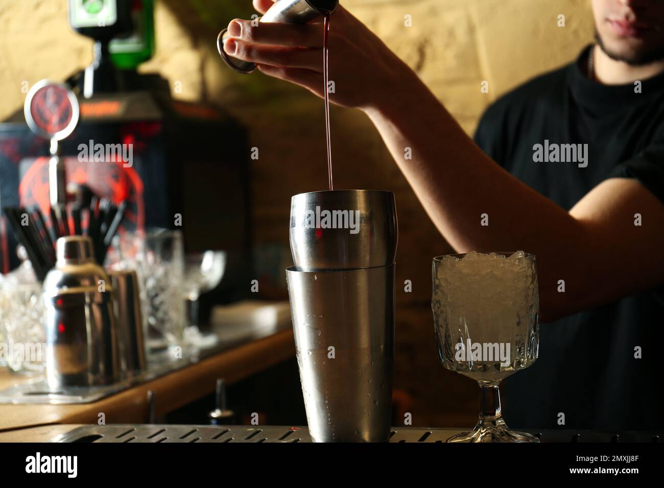 Bartender preparing fresh alcoholic cocktail at bar counter, closeup ...