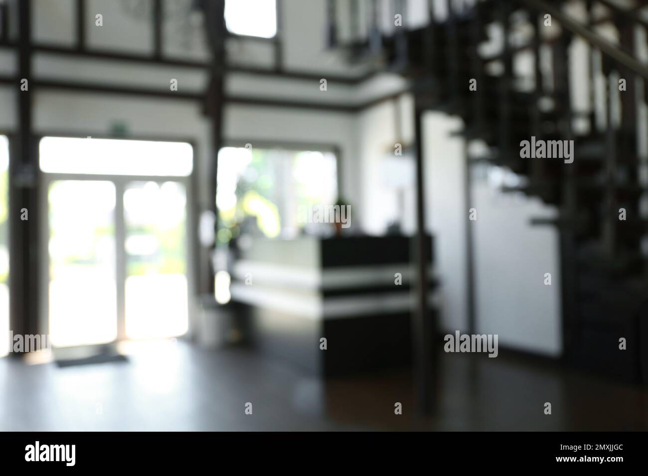 Blurred view of reception desk and stairs indoors Stock Photo - Alamy