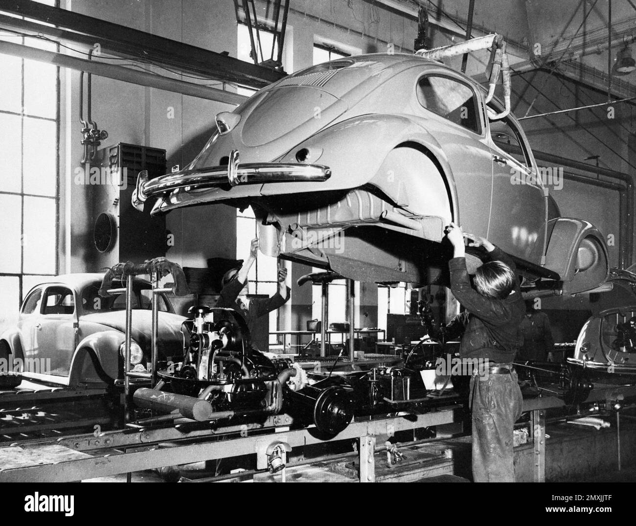 The body of the Volkswagen is swung into place as the chassis moves ...