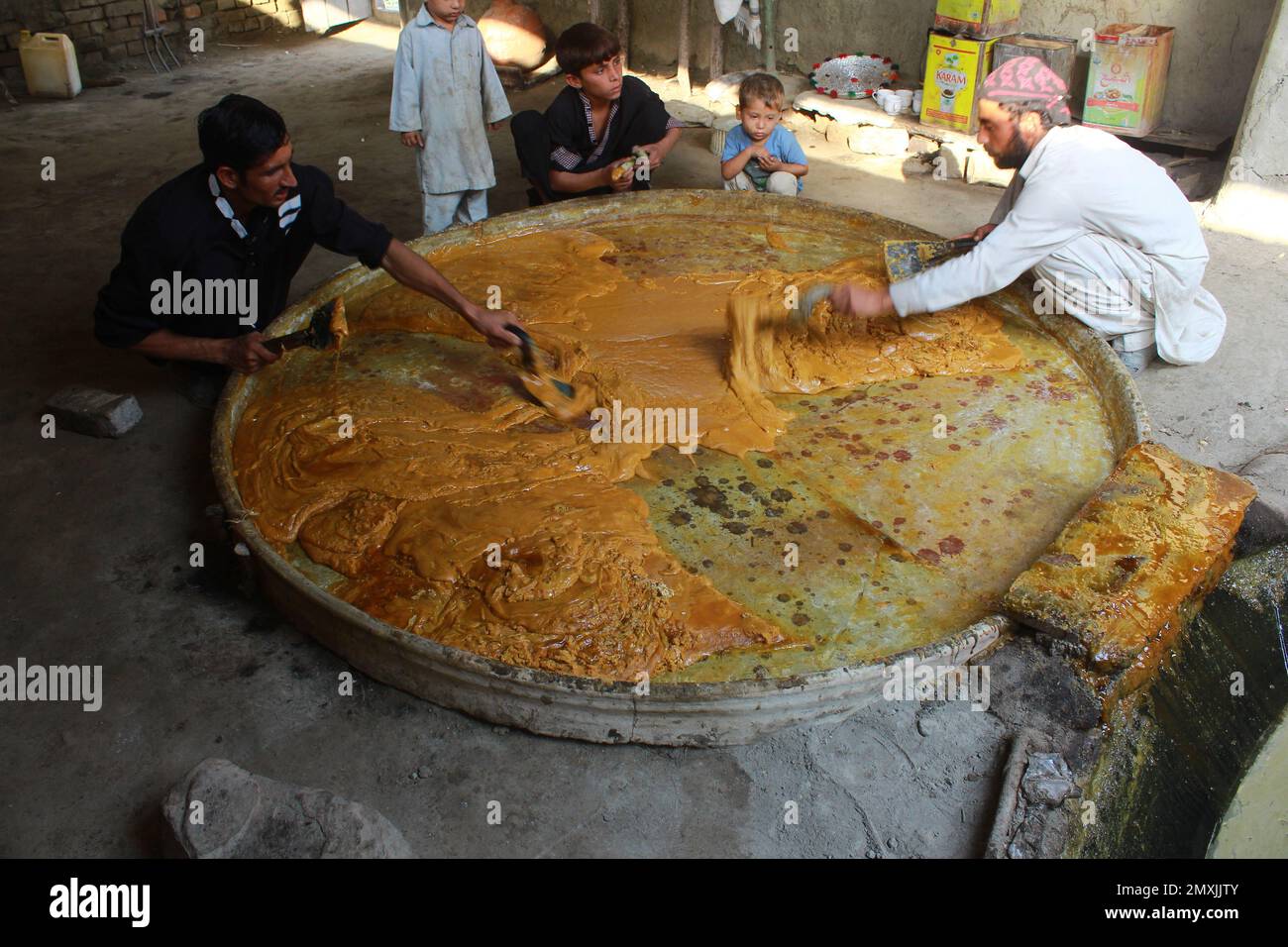 Pakistani vendors make ''gur,'' or jaggery, prepared from molasses of ...