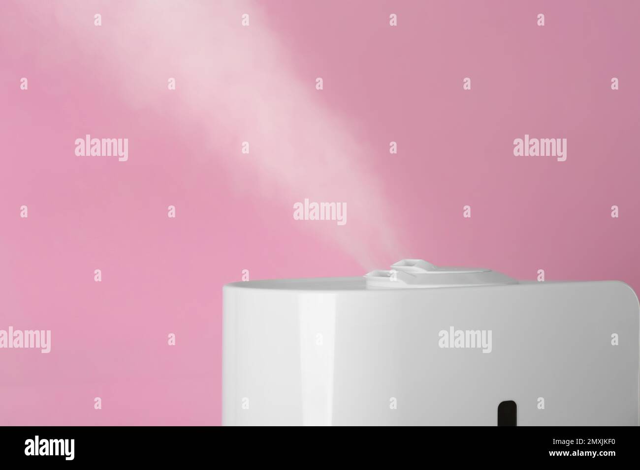 Modern air humidifier on pink background, closeup. Space for text Stock ...