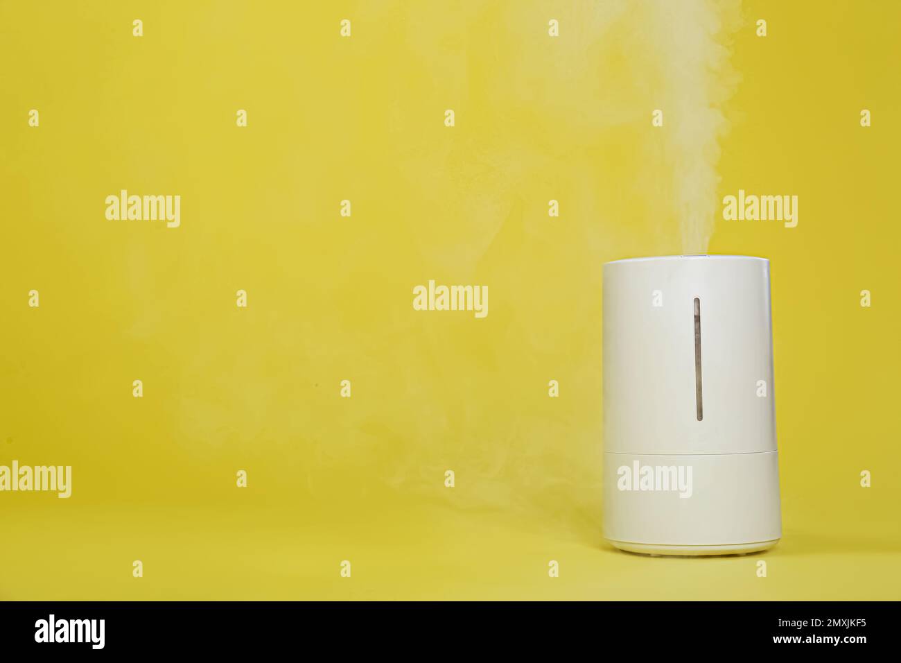 Modern air humidifier on yellow background. Space for text Stock Photo ...