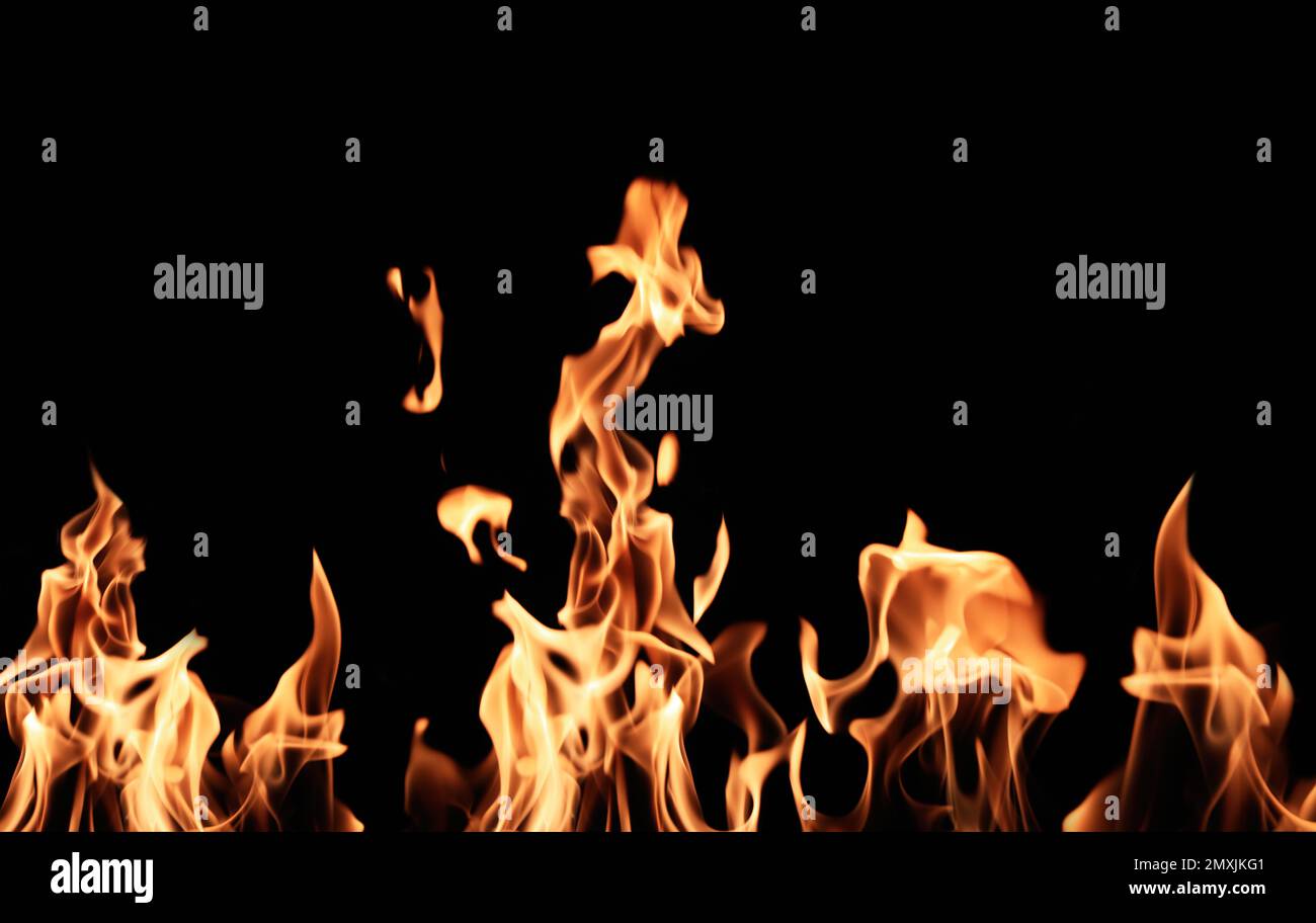 Beautiful bright fire flames on black background Stock Photo - Alamy