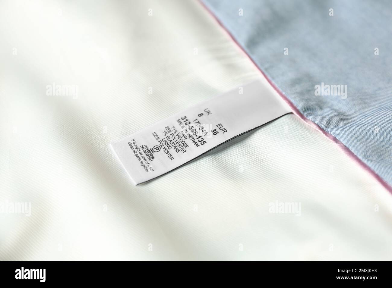 Clothing label with size and content information on light garment ...