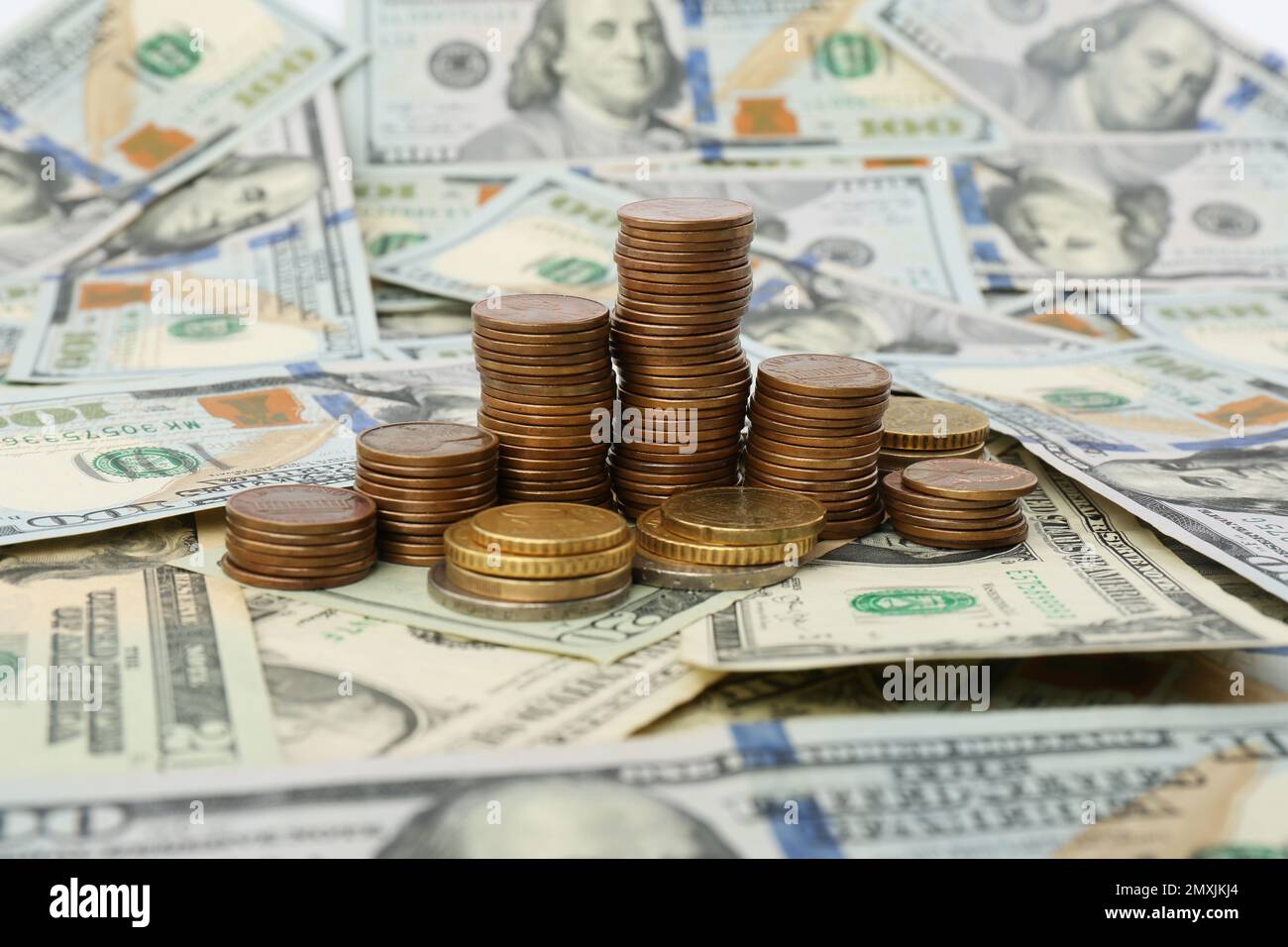 Stacked coins on American dollar bills, closeup Stock Photo - Alamy