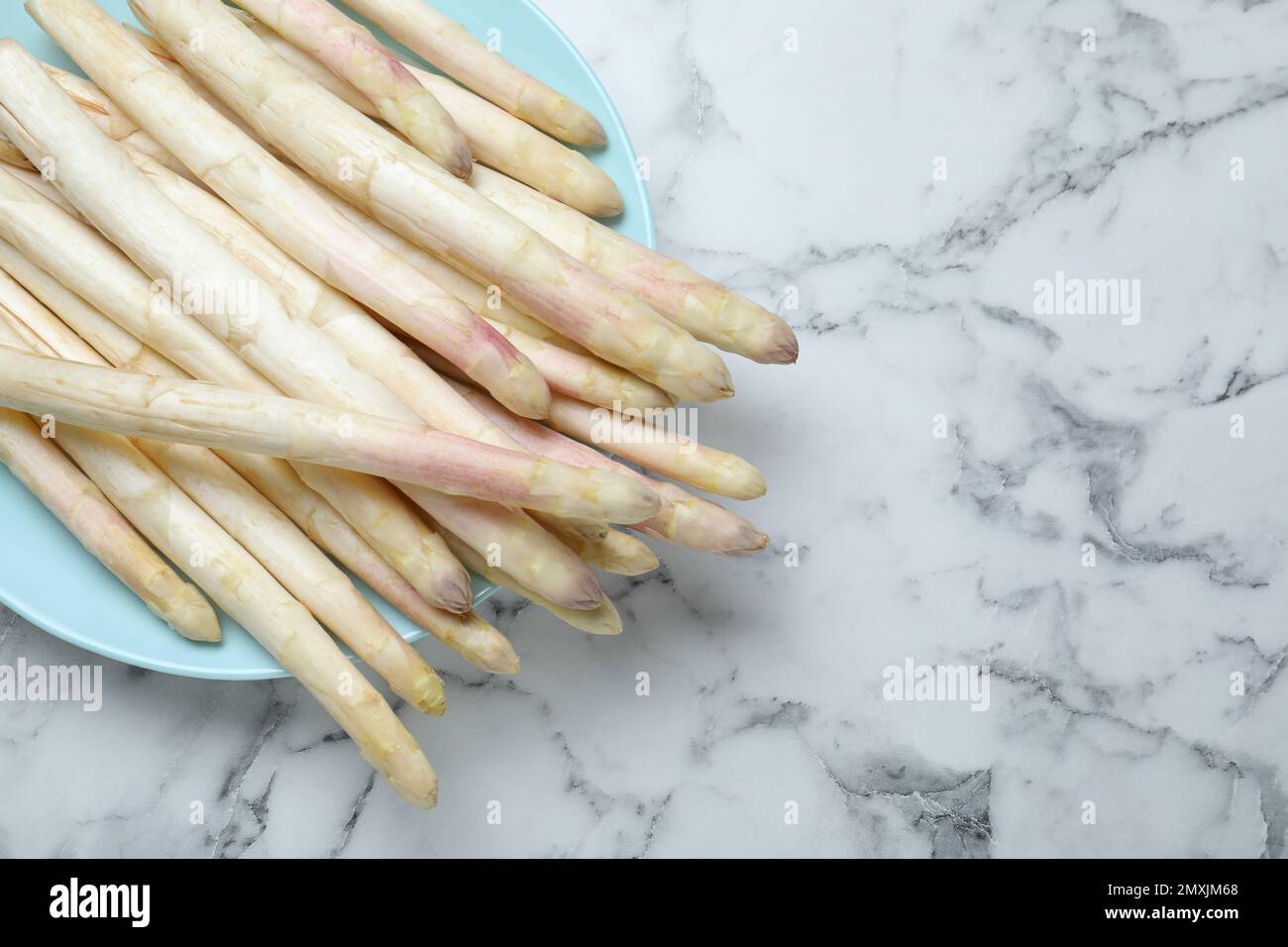 Fresh white asparagus on marble table, top view. Space for text Stock ...